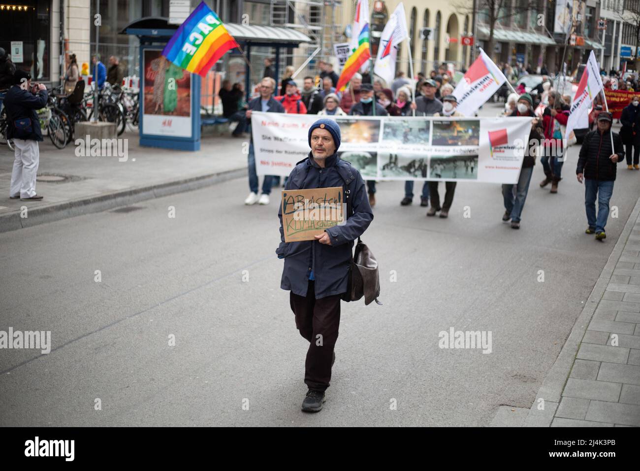 Protestor holds sign reading: " Disarm! Protect the climate! " On April ...