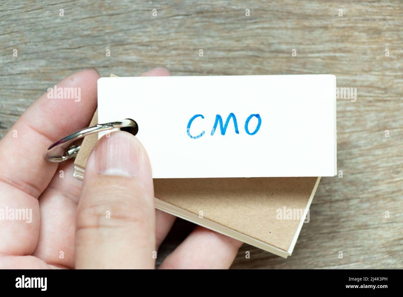 Man hold the flash card with handwriting word CMO (Abbreviation of ...