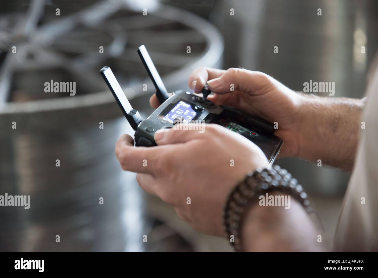 Man hands holding transmitter with attached mobile phone device and ...