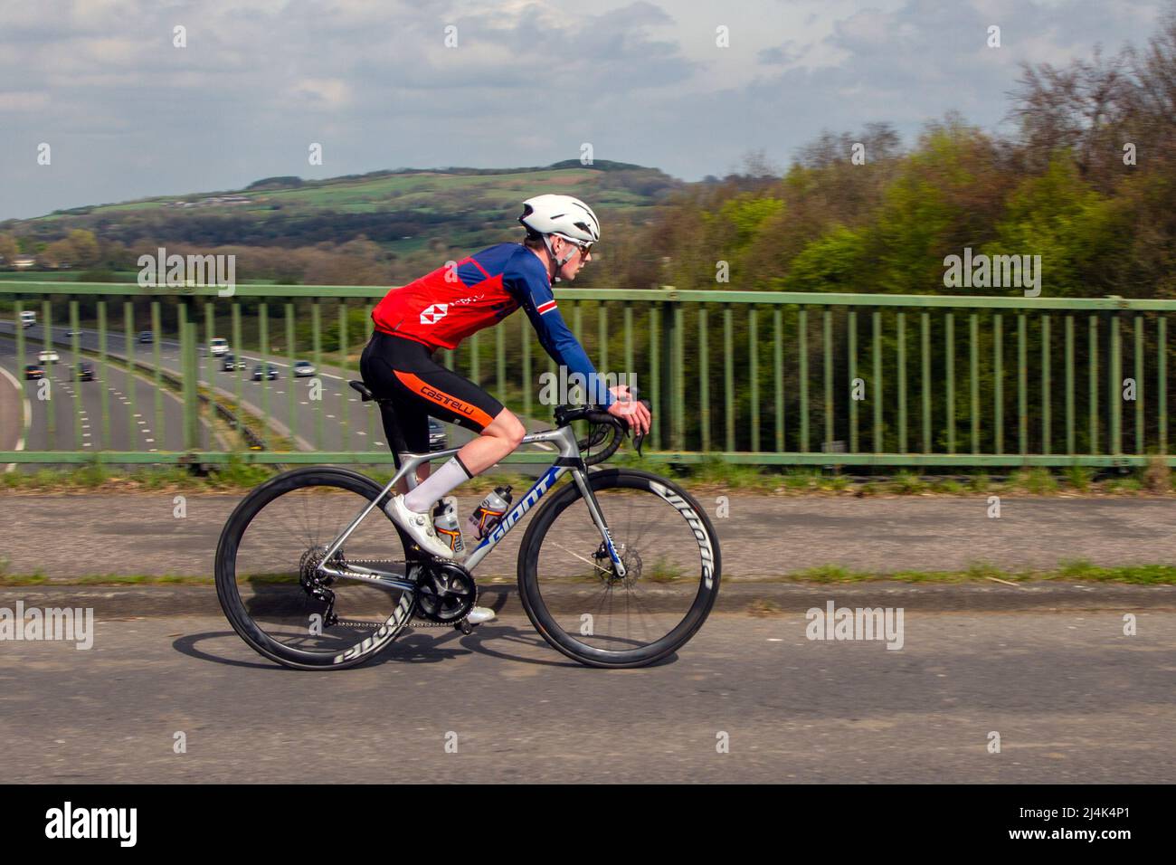 Male cyclist riding Giant sports road bike on countryside route ...
