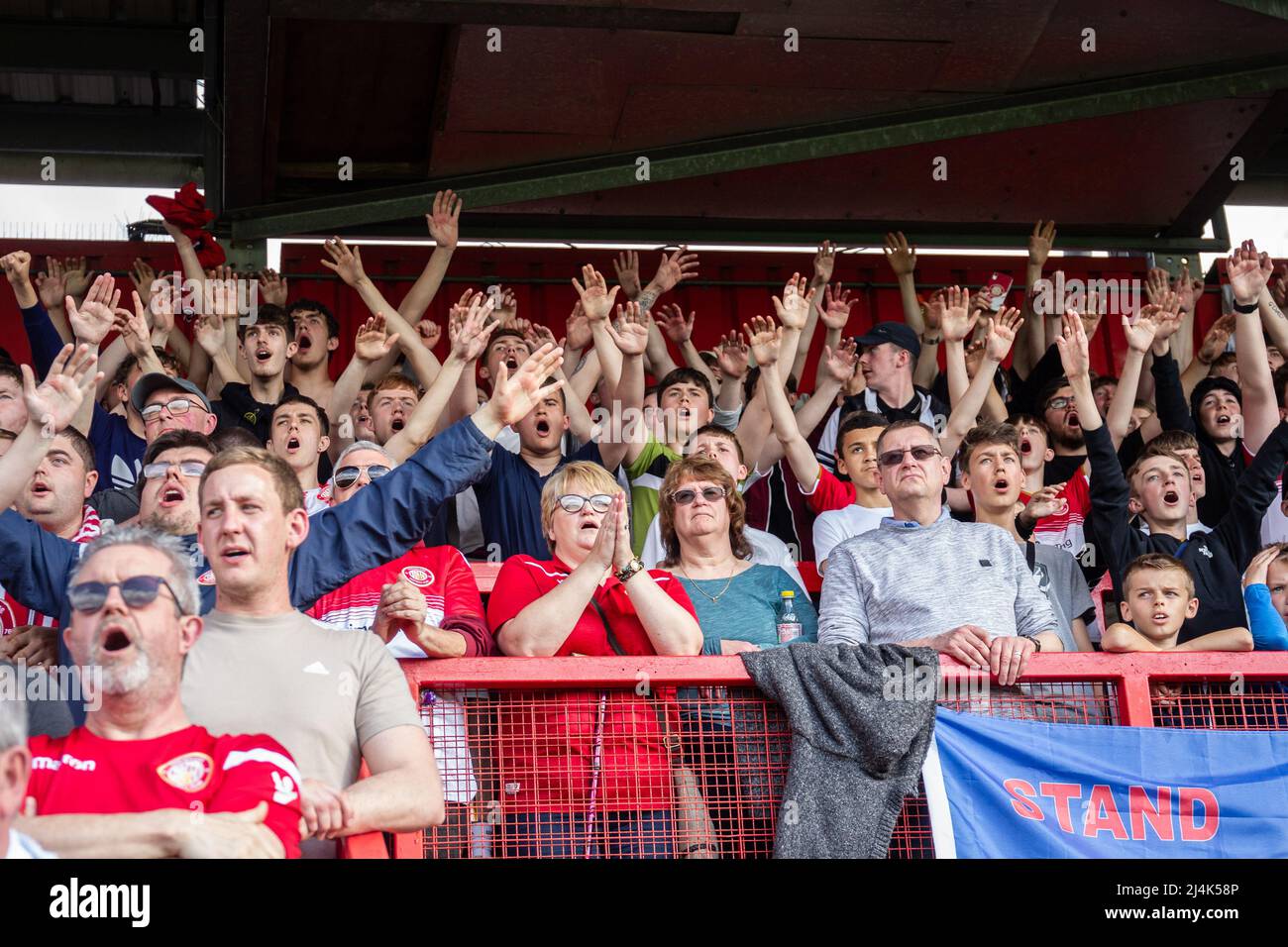 Football / soccer fans and spectators standing on terrace at lower ...