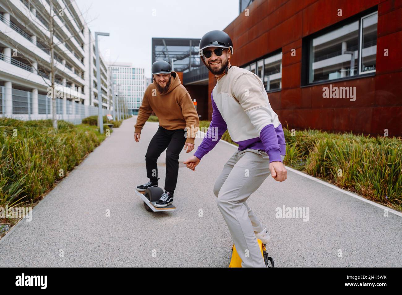 Two Men ride future Segway. Electric skateboard crew. the future live ...