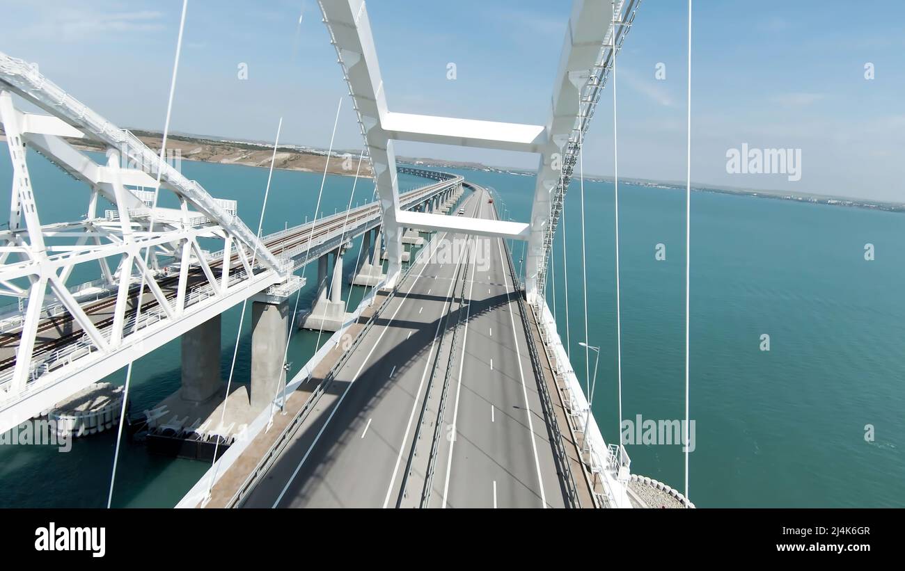 Huge bridge. Drone view. Action. A long bridge over the ocean on which ...