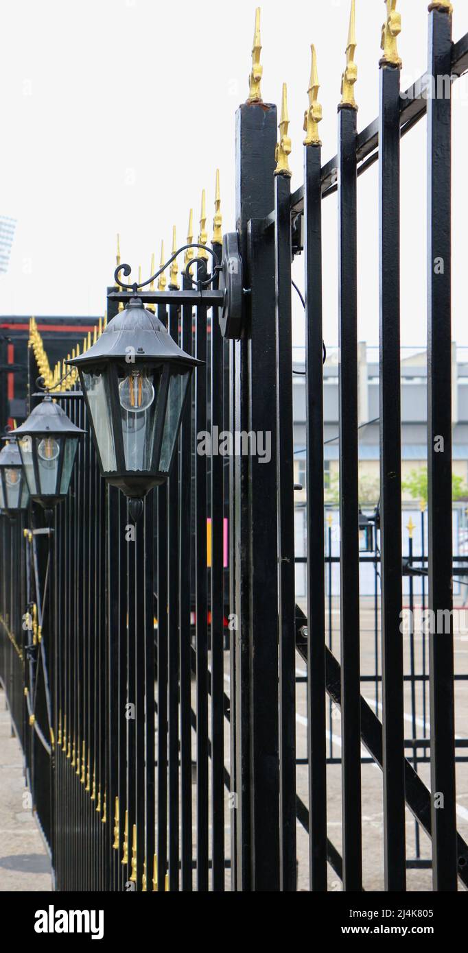 Black painted metal fence with lamps around the Bacanal circus close up ...