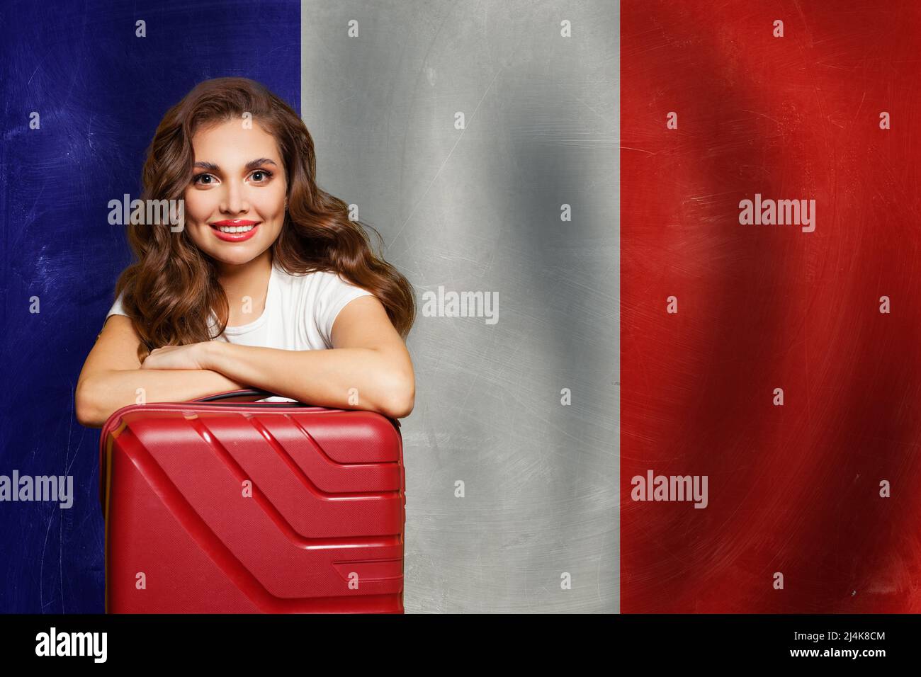 Welcome to France concept. Beautiful woman with red suitcase on French ...