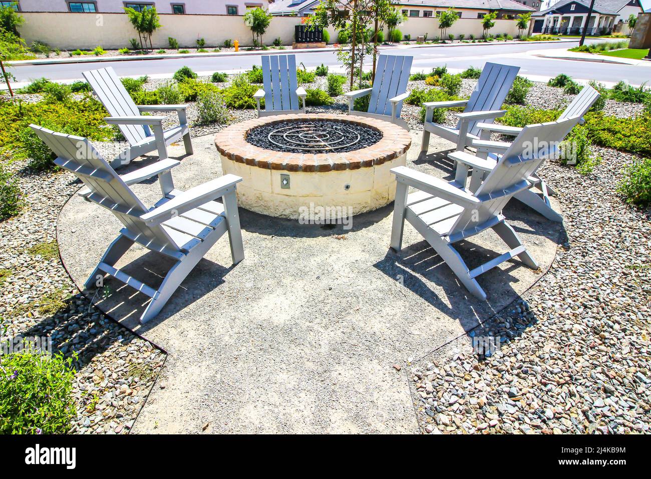 Circular Fire Pit With Seven Wooden Arm Chairs Stock Photo - Alamy