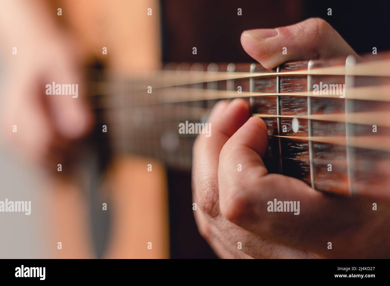close up caucasian male hand playing making a chord on acoustic guitar ...