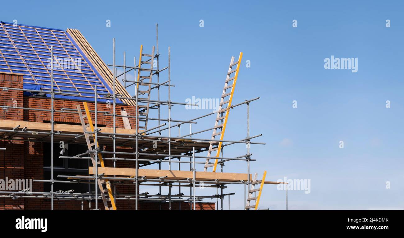 Scaffolding pile platform against a newly built row of houses on a ...