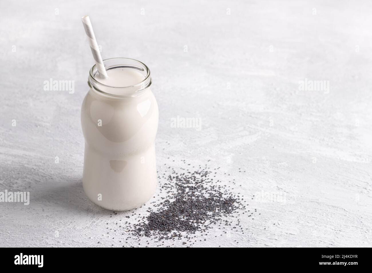 Fresh poppy milk in bottle with seeds on light background. healthy diet ...
