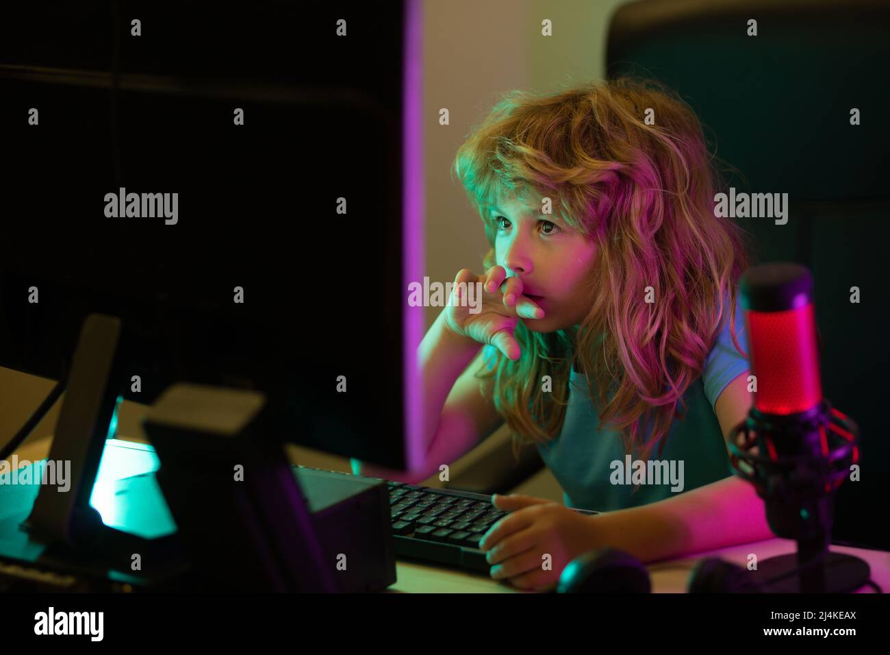 Child playing computer games or studying on pc computer. Kid gamer on ...