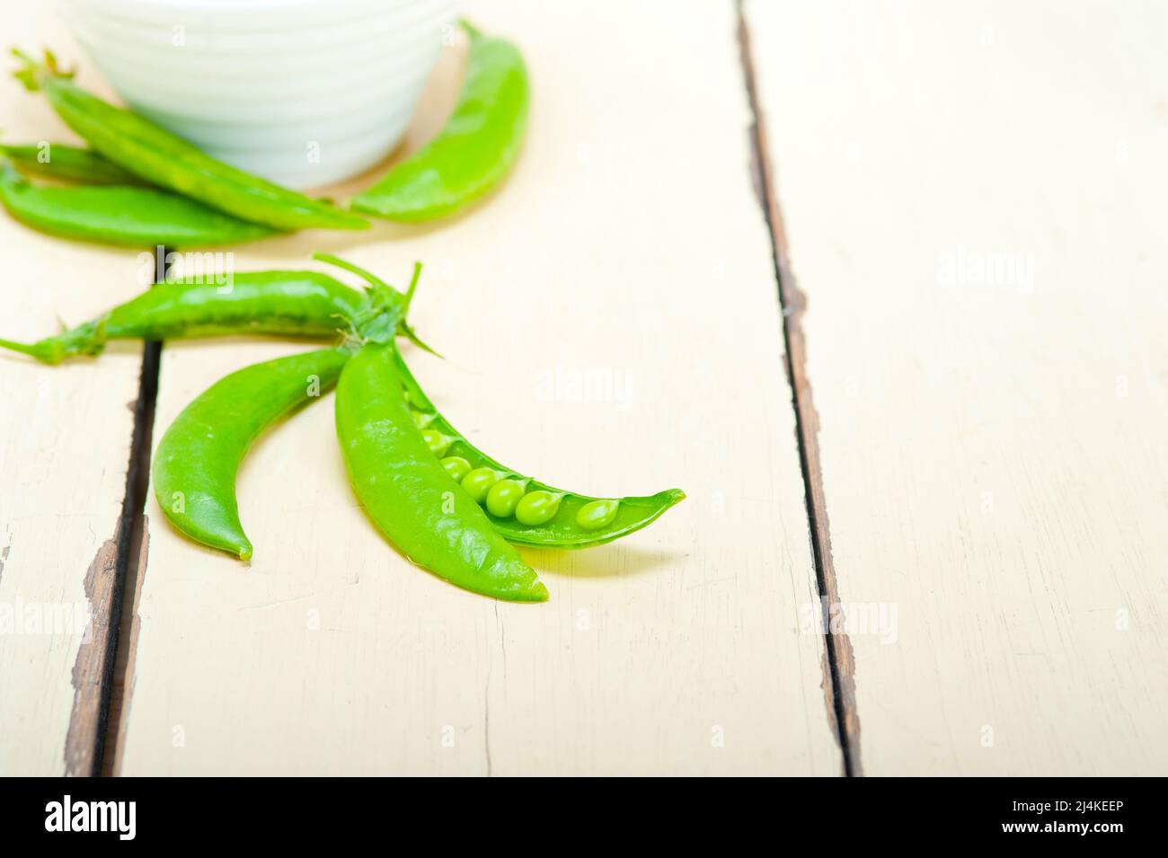 hearthy fresh green peas over a rustic wood table Stock Photo - Alamy