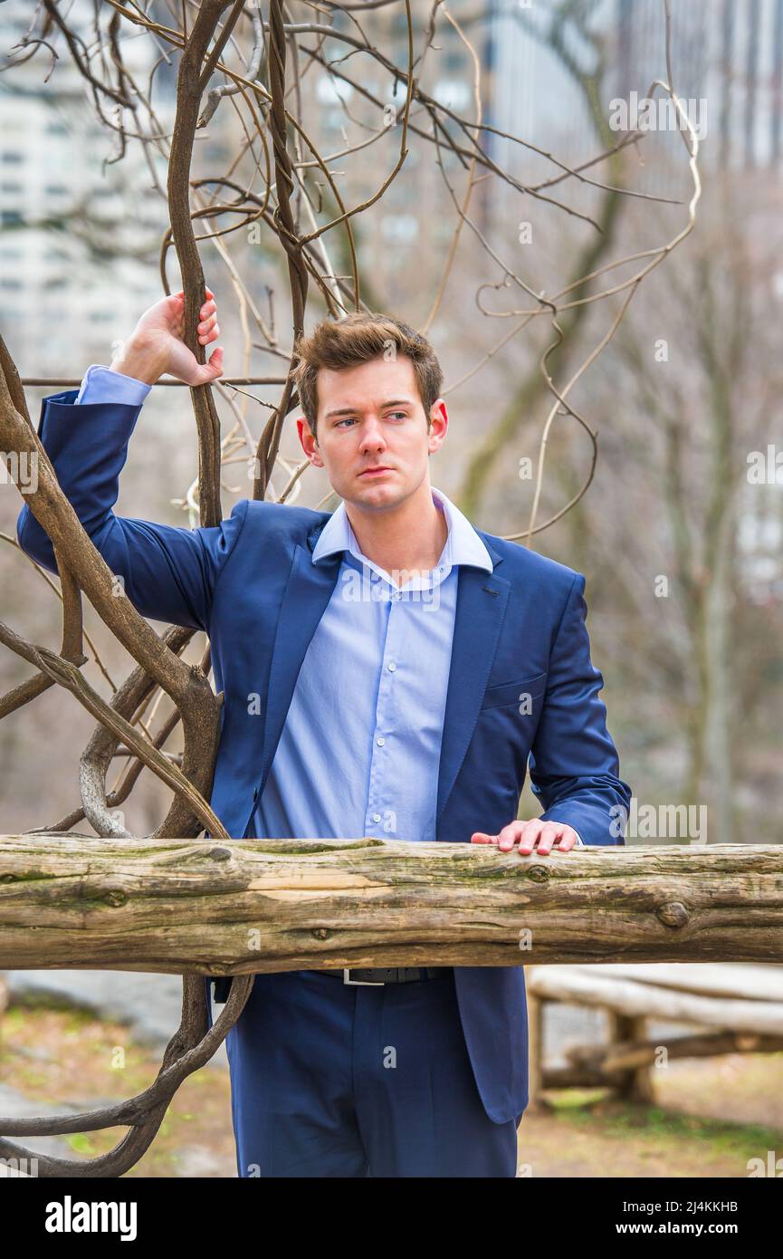 A young handsome guy is pondering at small woods and into deeply ...