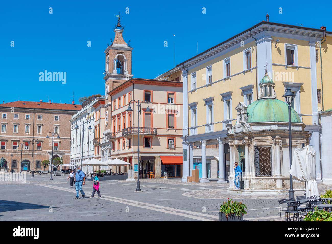 Rimini, Italy, September 2, 2021: people are passing a clock tower on ...
