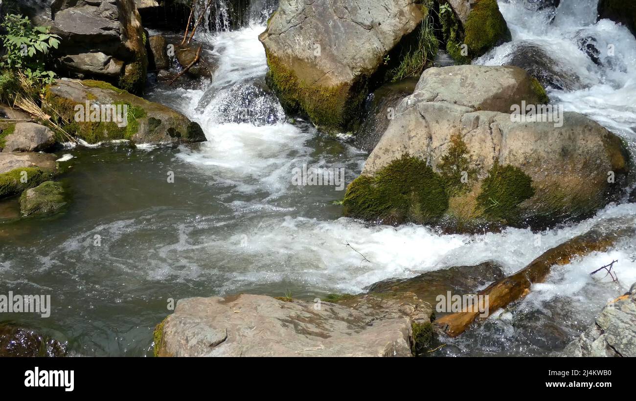 Mountain river. Fast stream moving among rocks Stock Photo - Alamy