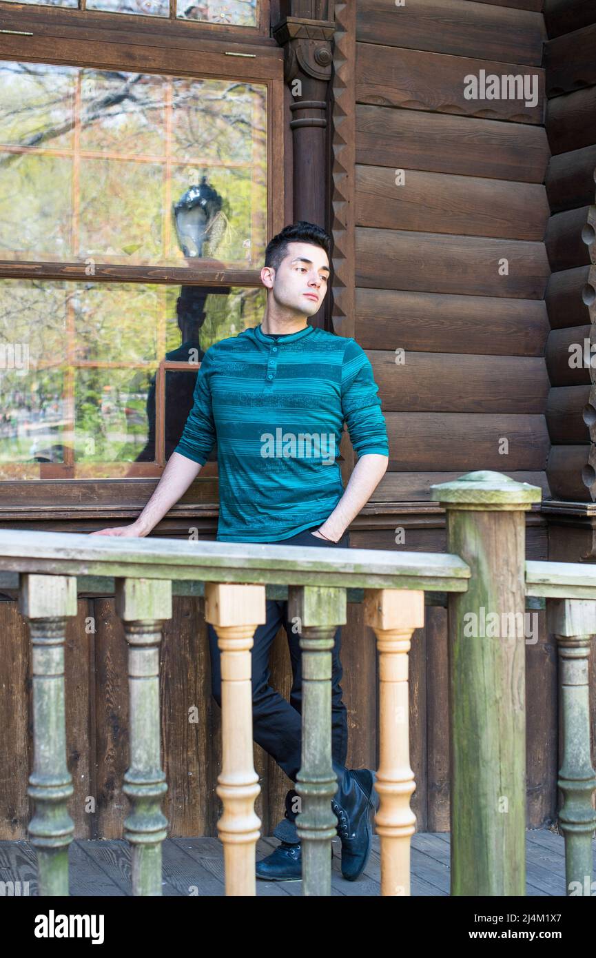 A young handsome guy is standing by a window and thinking Stock Photo ...