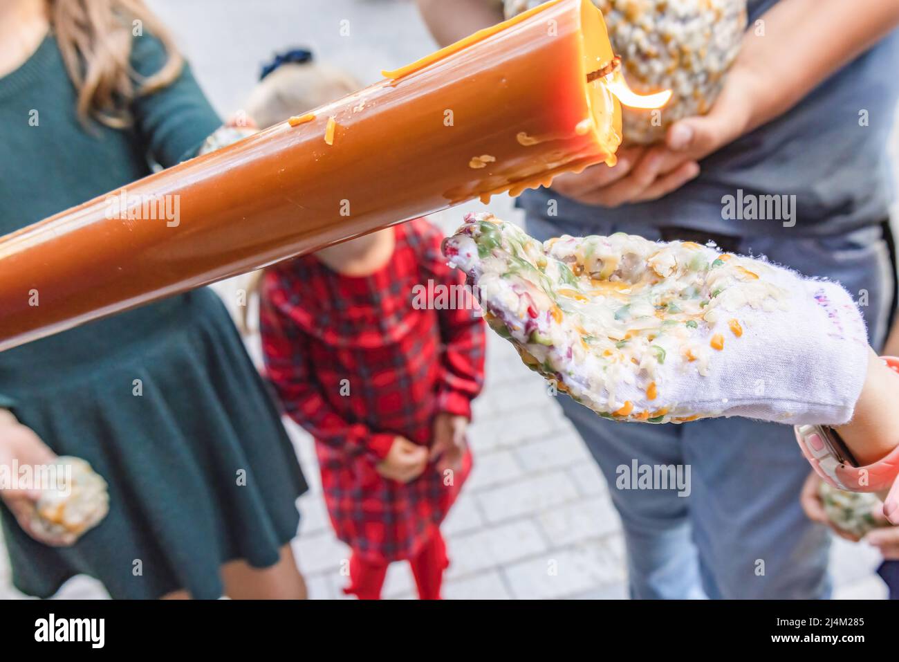 Close Up of the hand of a girl kid with a white glove collecting wax ...