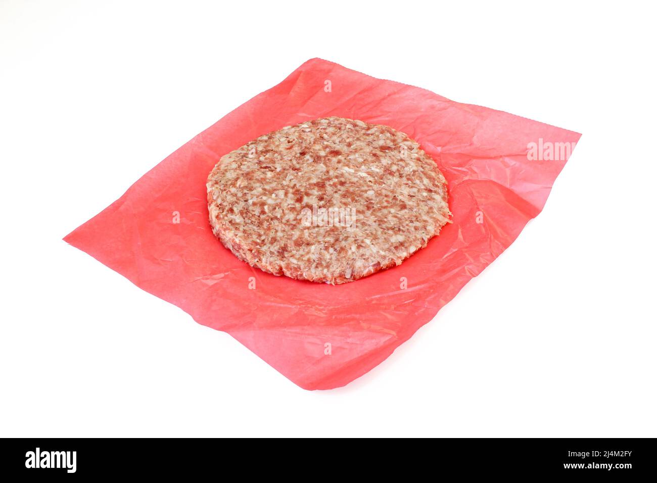 Raw beef meat patty on red plastic paper isolated on white background ...