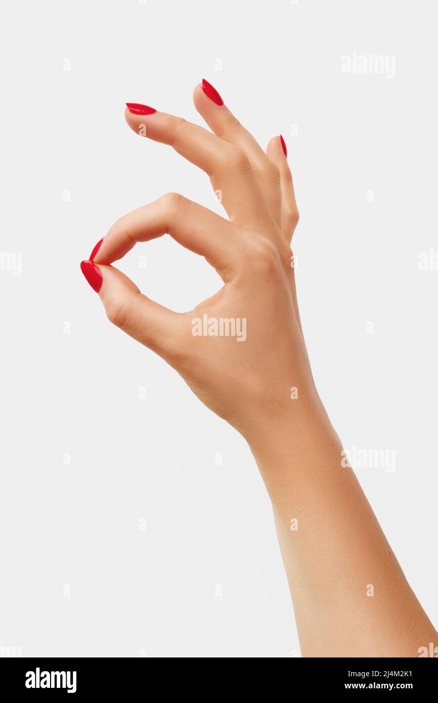 Hand OK sign isolated on white background. Woman hand with red manicure ...