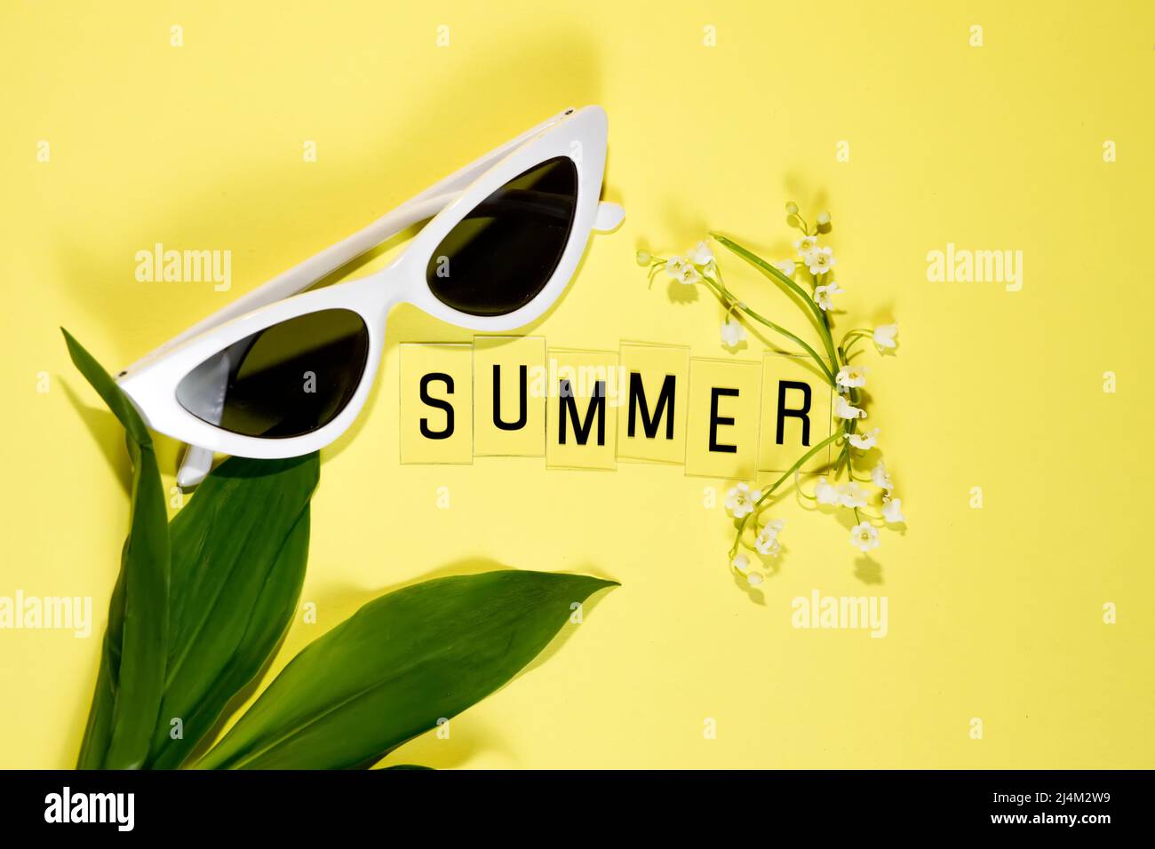 Summer layout of flowers, leaves, glasses and text with the inscription ...