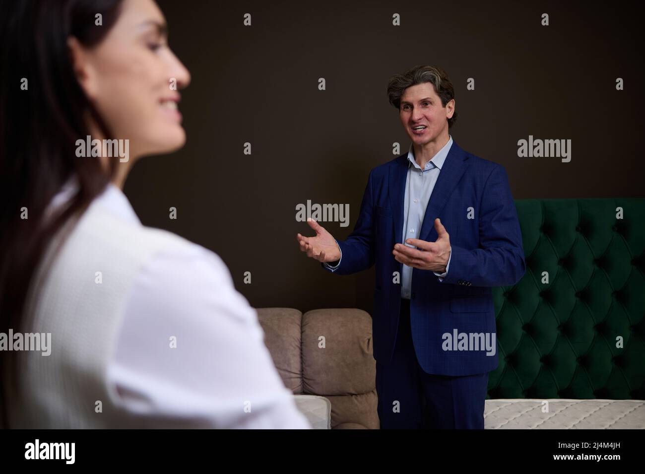 Sales rep, assistant, retail consultant explaining benefits of ...