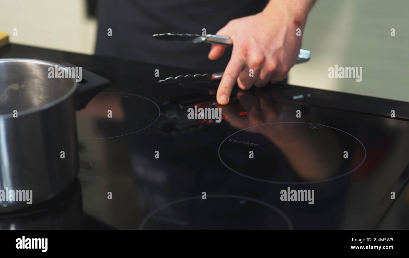 The cook turned on the electric stove. ART. The cook started cooking ...