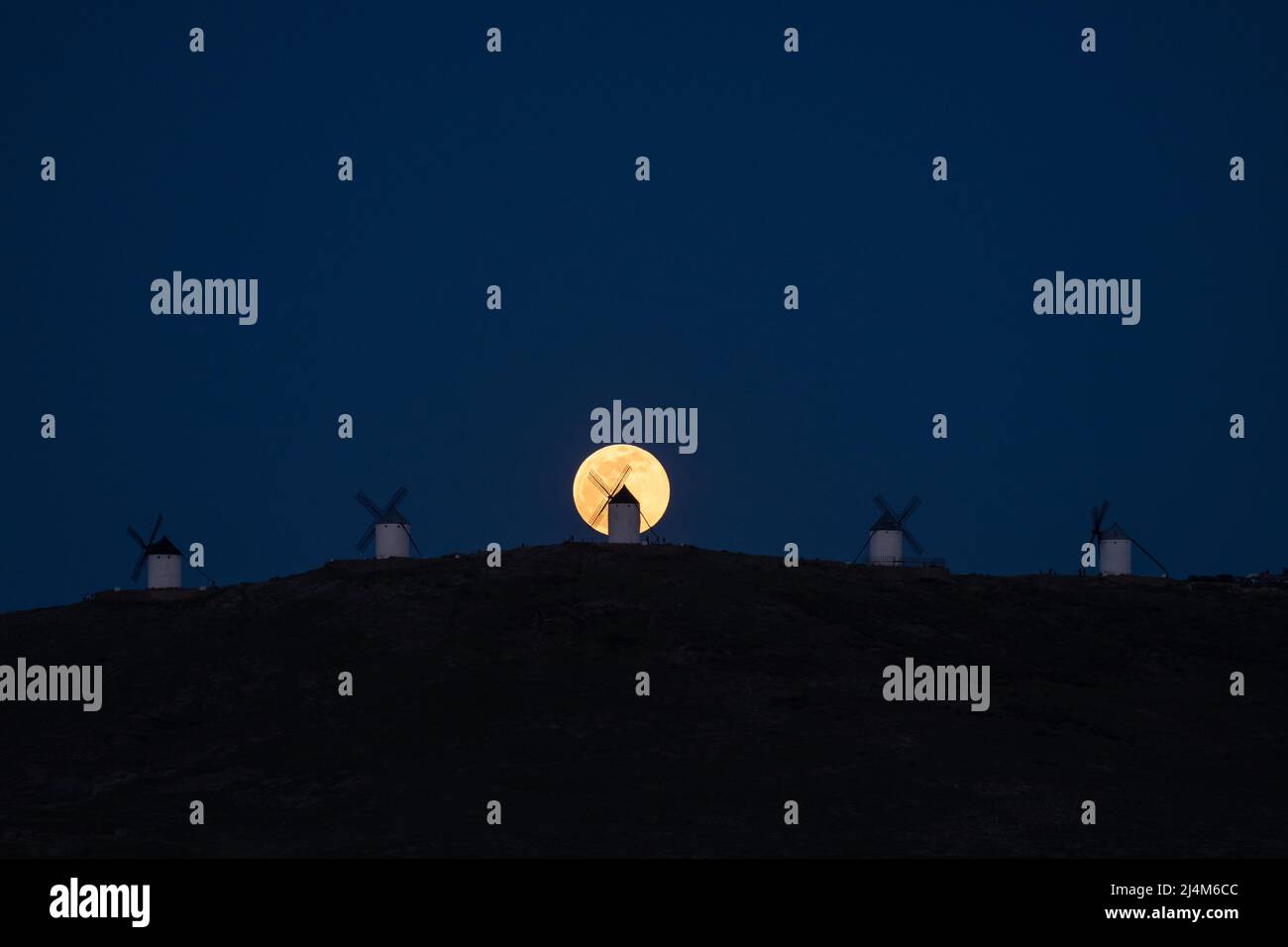 Consuegra, Spain. 16th Apr, 2022. The full moon rises over a windmill ...
