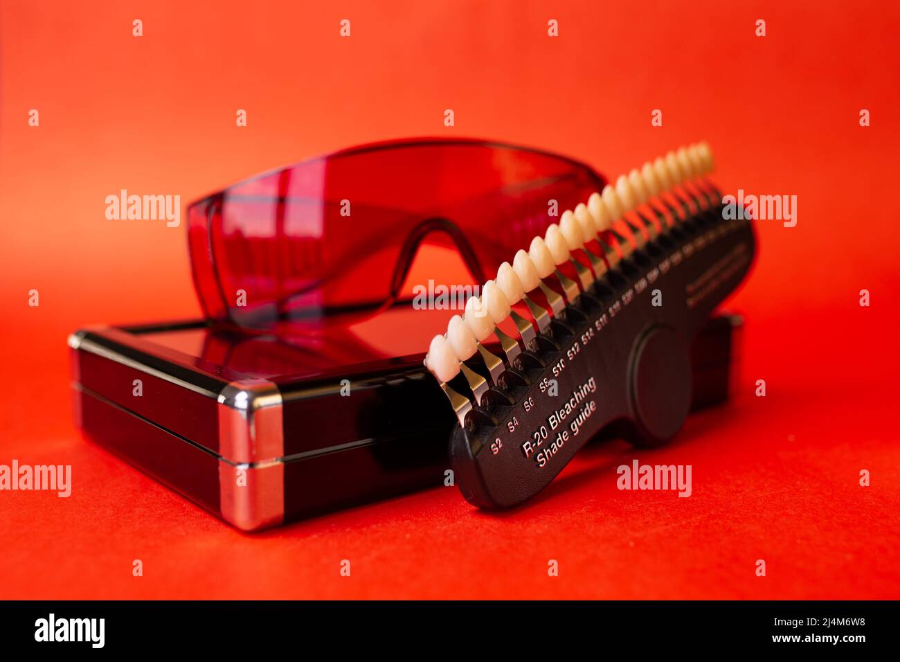 Table of teeth color. Scale on a red background close-up Stock Photo ...