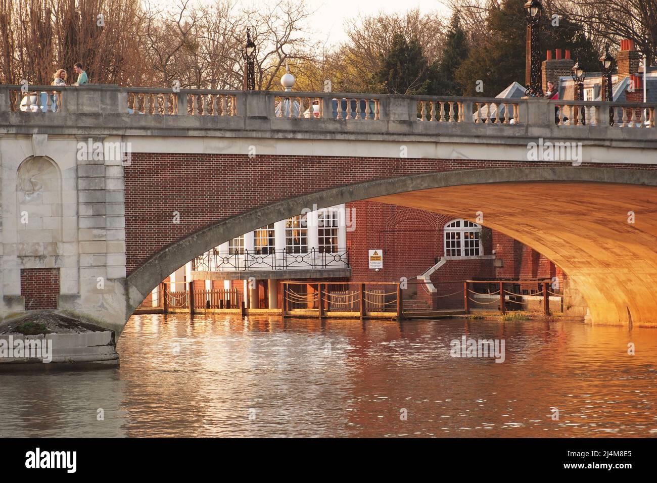 A view of Hampton Court bridge from the stern of a river cruiser ...