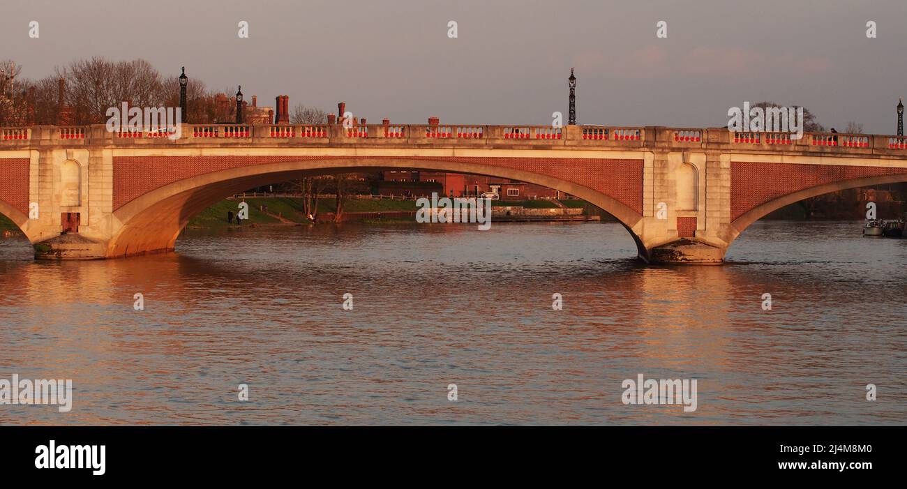 Hampton Court bridge over the River Thames, in evening, spring sunshine ...