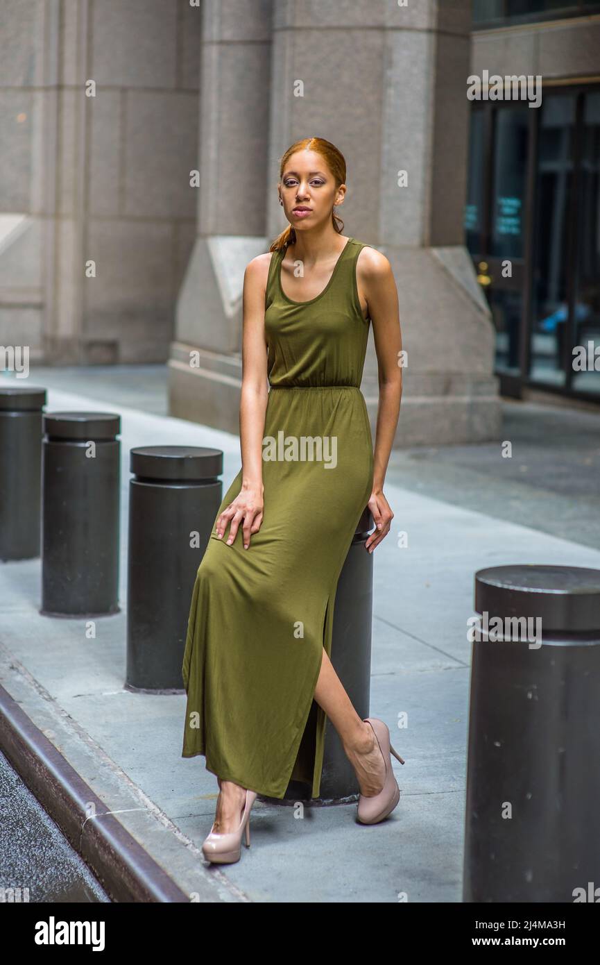 Woman Relaxing Outside. Dressing in a green Maxi Tank Dress, high heels ...