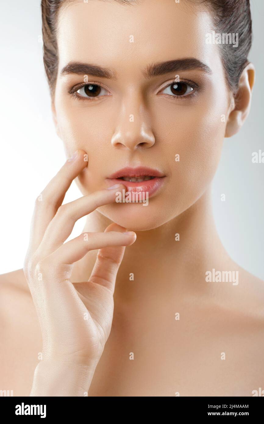 Beauty Face. Beautiful Woman With Natural Makeup touch own face. Girl ...