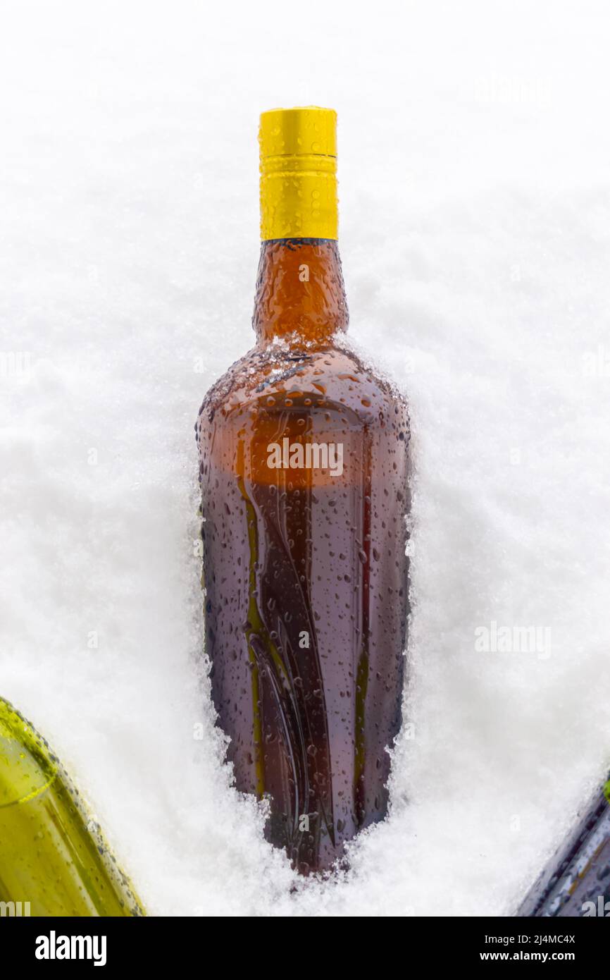 bottle of spirit in the cold snow Stock Photo - Alamy