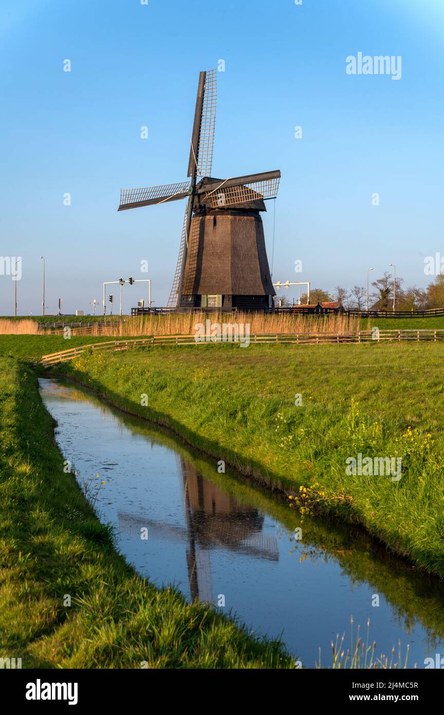 Traditional Dutch windmill reflection on the canal Stock Photo - Alamy