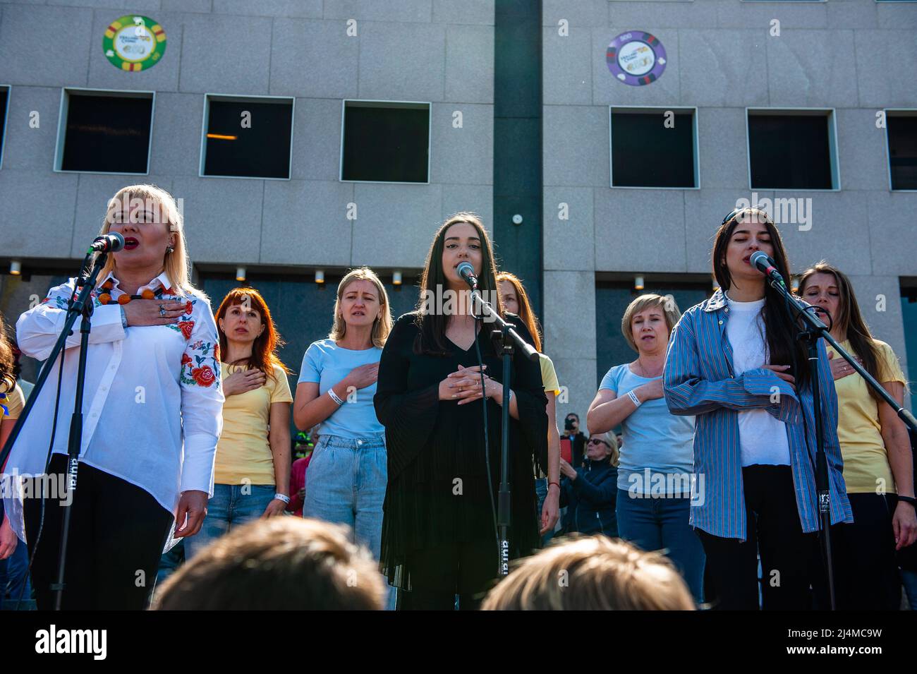 Ukrainian women hosted in the city are seen singing the Ukrainian ...