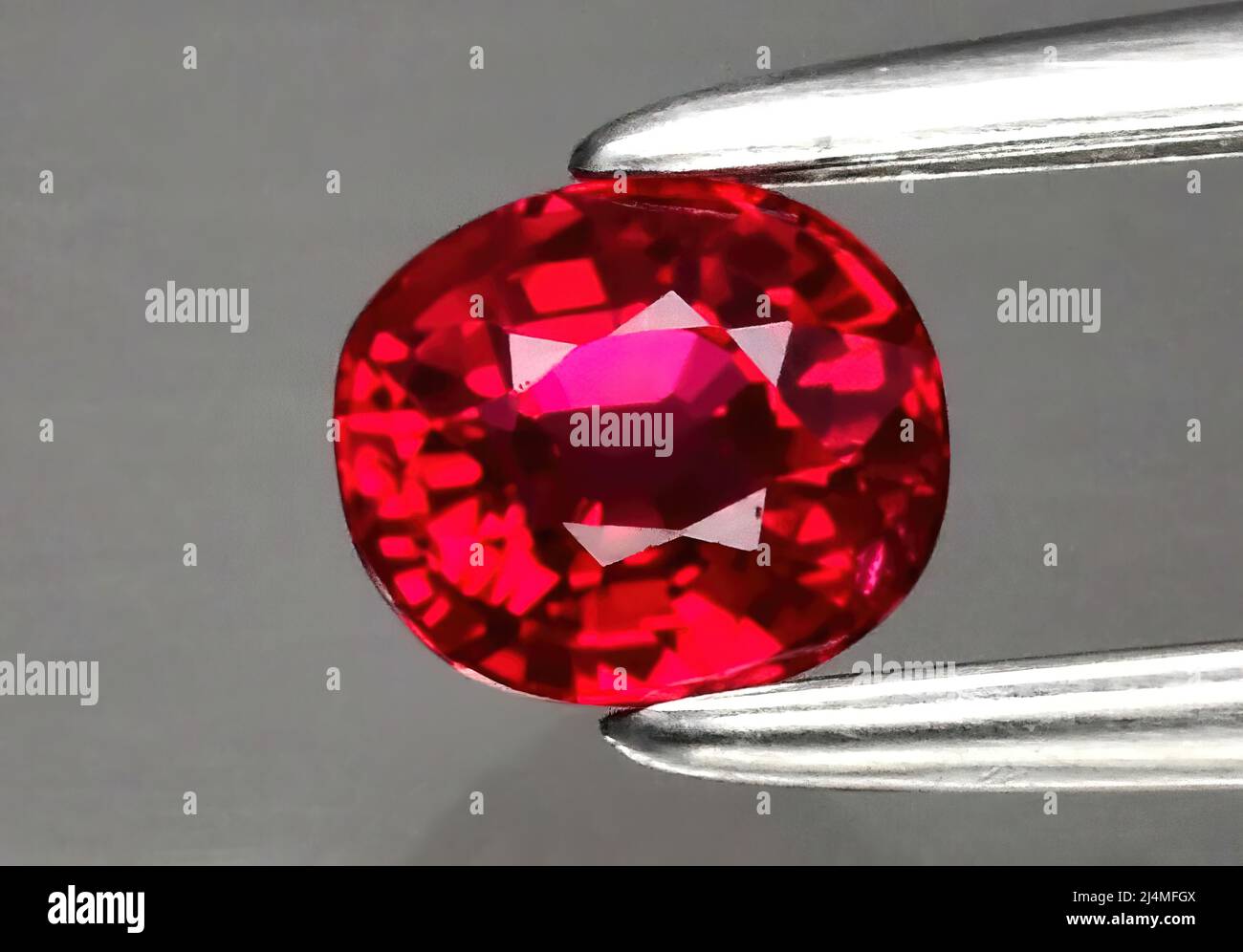 Natural precious red ruby in tongs on a background Stock Photo - Alamy