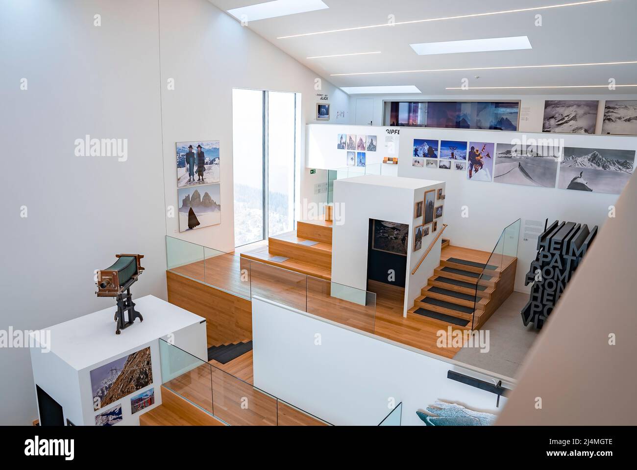 Interior of modern museum with various paintings and retro camera Stock ...