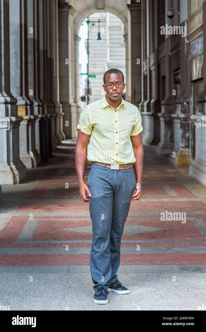 Dressing in a light blue shirt, a pattern tie, gray pants, wearing ...