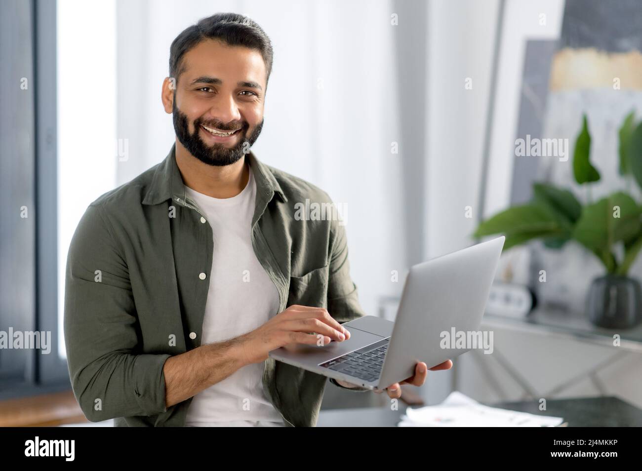 Portrait of a handsome positive Indian or Arabian successful man ...