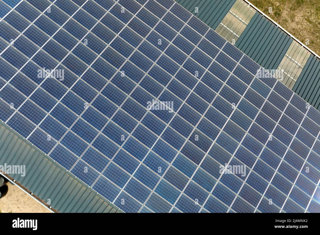 Aerial view of blue photovoltaic solar panels mounted on industrial ...