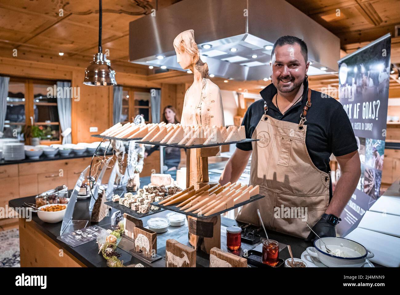 Happy male chef standing behind counter at food distribution in hotel ...