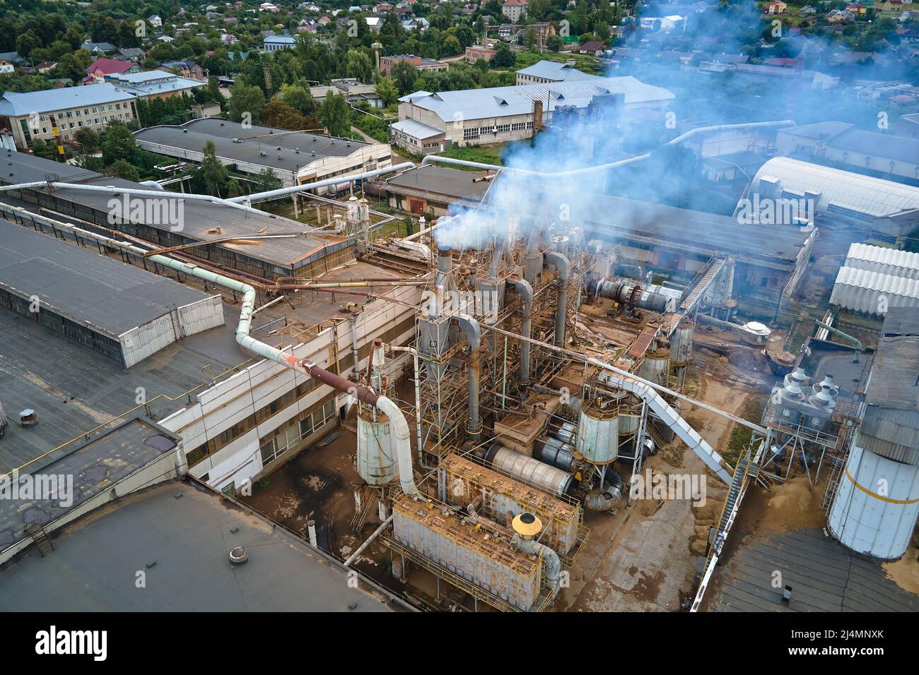 Aerial view of wood processing factory with smoke from production ...