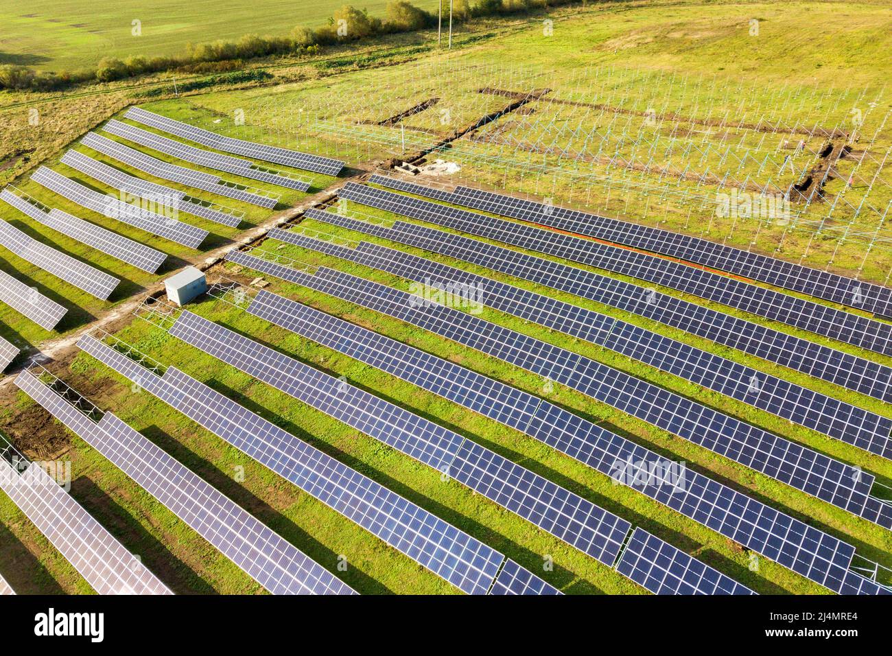 Aerial view of solar power plant under construction on green field ...