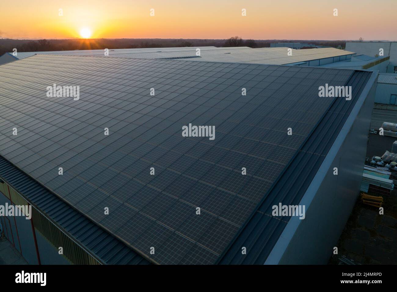 Blue photovoltaic solar panels mounted on building roof for producing ...
