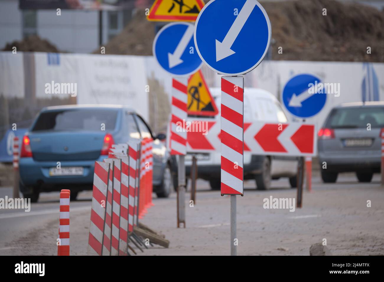 Roadworks warning traffic signs of construction work on city street and ...
