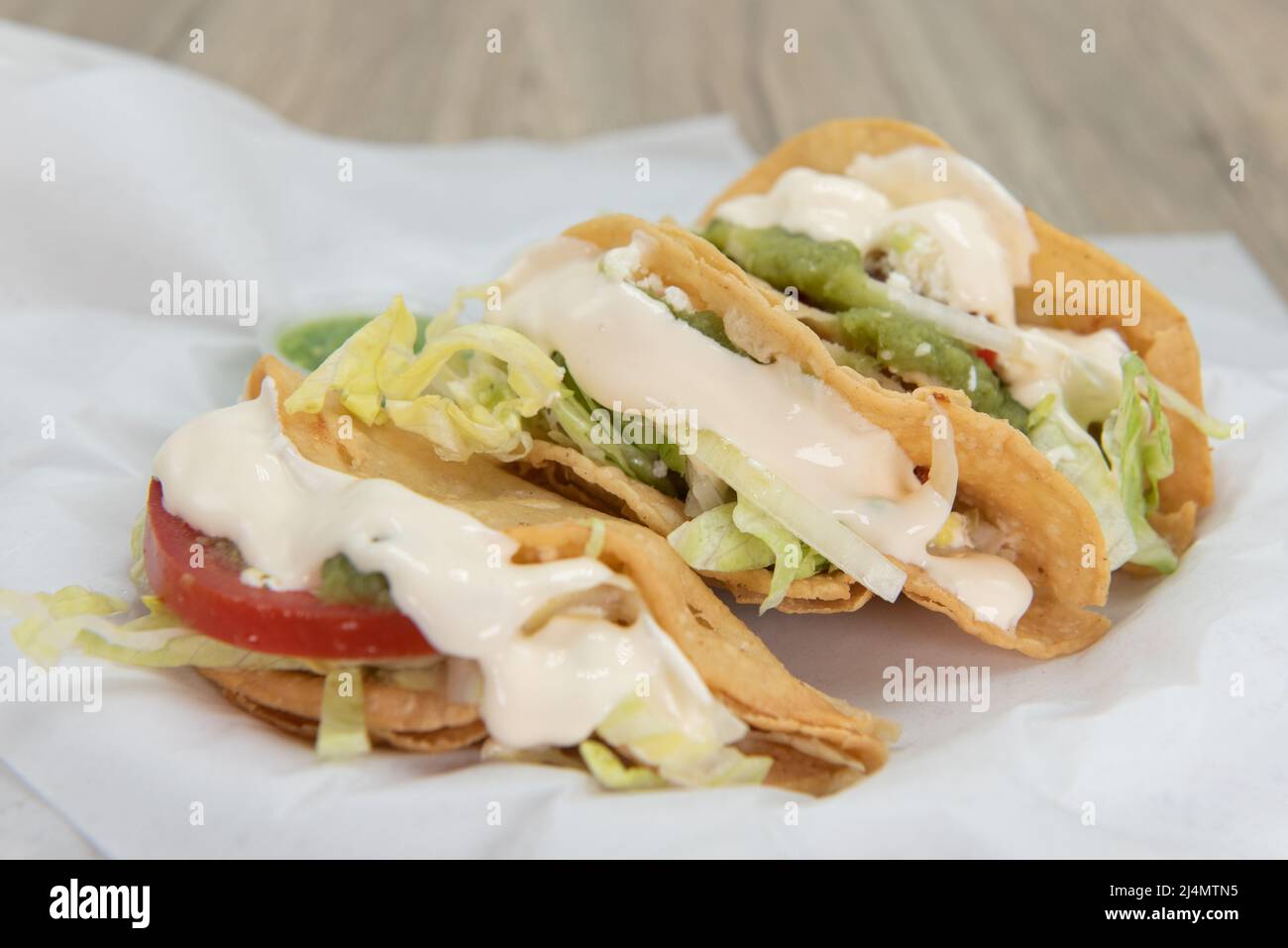 Three tacos de papas are loaded with meat and potatoes for a very ...