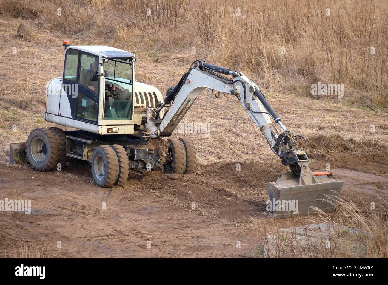 Earth moving tractor preparing place for future house foundation ...