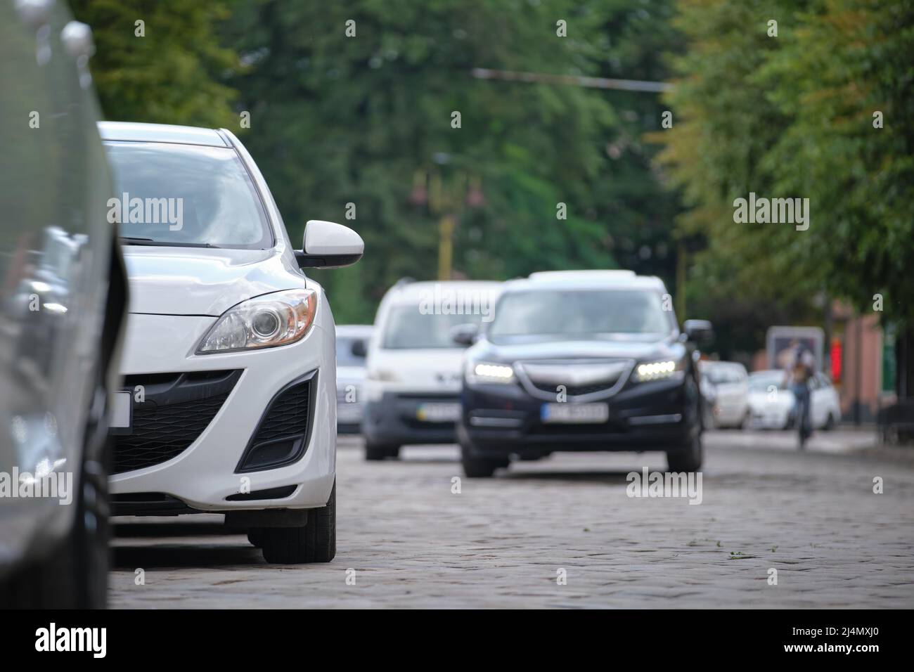 Cars parked in line on city street side. Urban traffic concept Stock ...