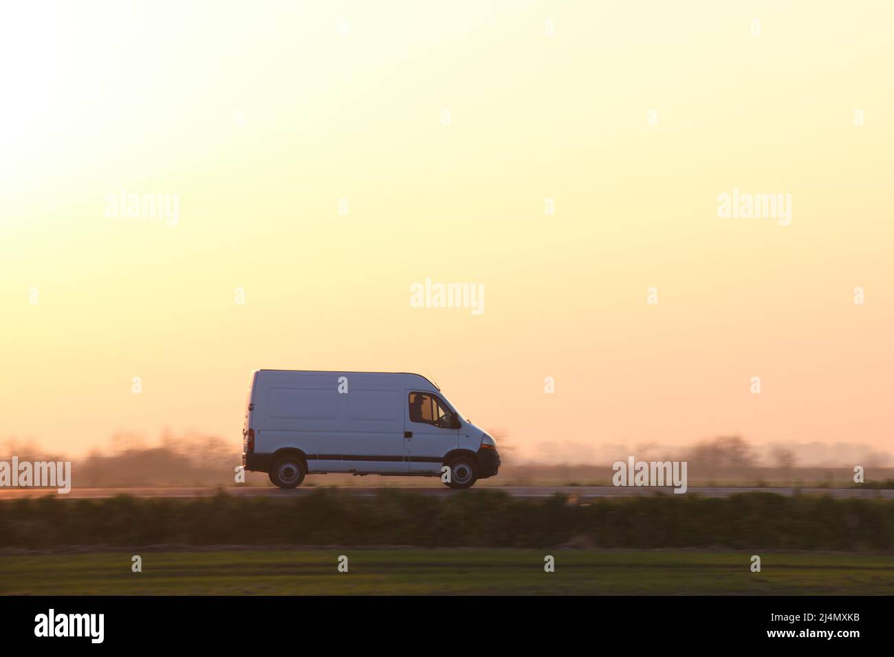 Small cargo van driving on highway hauling goods. Delivery ...