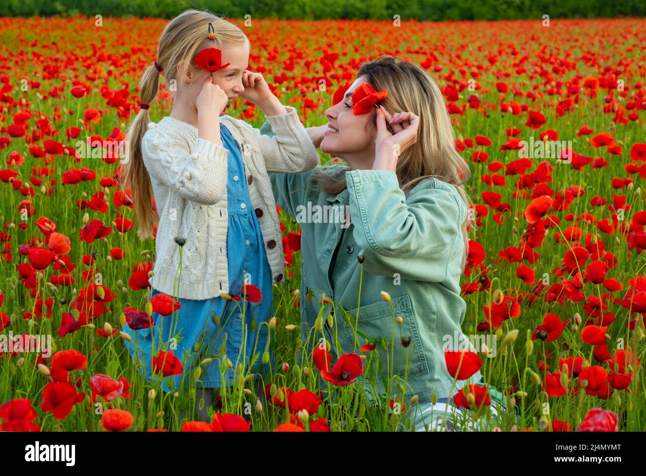 Beautiful child girl with young mother are wearing casual clothes in ...