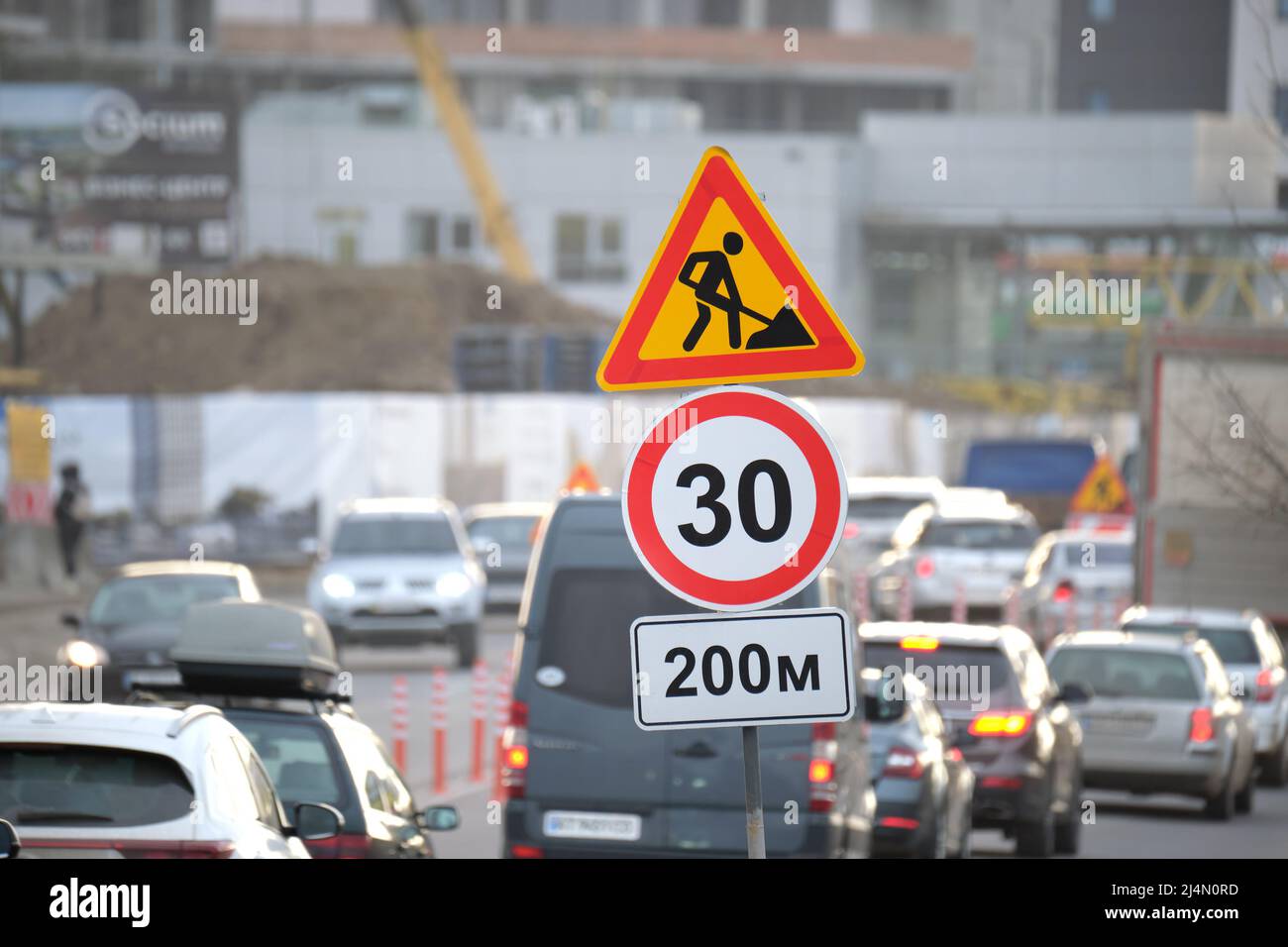 Roadworks warning traffic signs of construction work on city street and ...